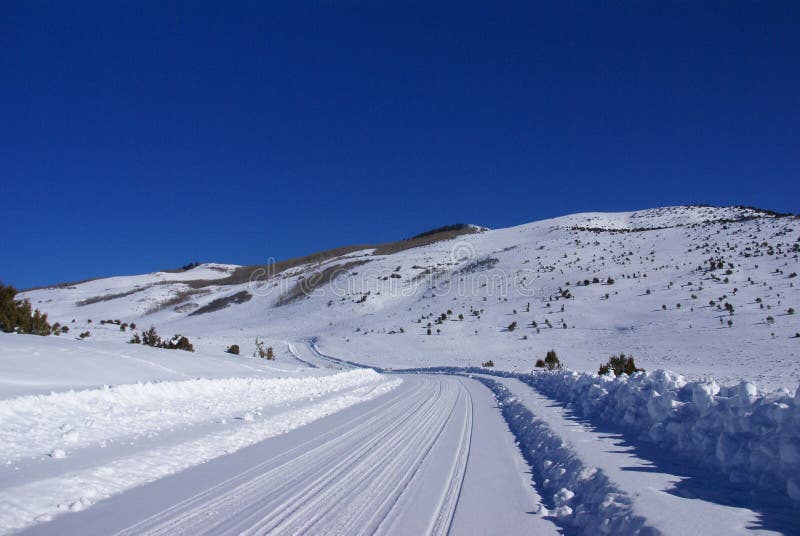 Tracks on Snow Covered Road in Mountain Stock Photo - Image of bare ...