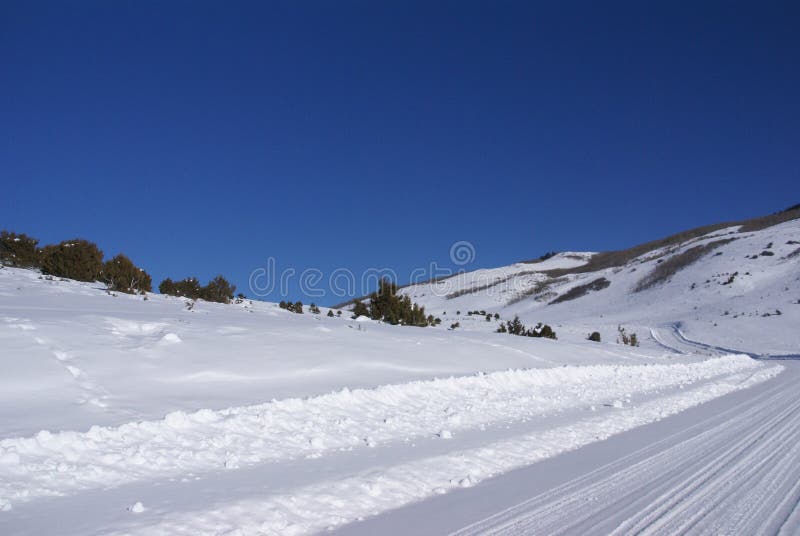 Tracks on Snow Covered Road in Mountain Stock Photo - Image of snow ...