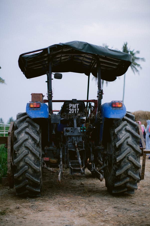 Blue tractor in the farm editorial photography. Image of farming ...