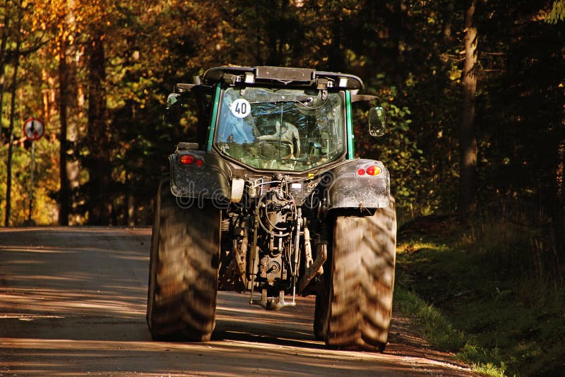 Tractor Driving Along a Forest Road Stock Photo - Image of environment ...