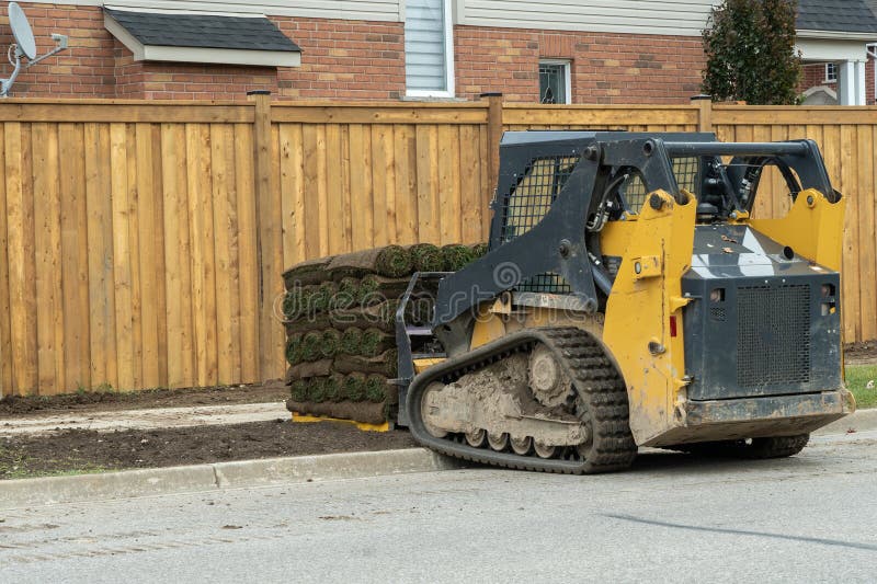 The Tractor Brought Rolls of Grass for Laying on the Ground Stock Image ...