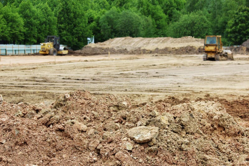 Tractor and Compactor are Leveling and Compacting the Surface of the ...