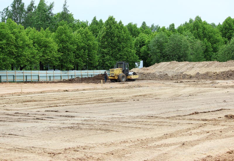 Tractor and Compactor are Leveling and Compacting the Surface of the ...