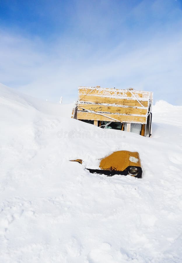 Tractor covered with snow stock photo. Image of land - 74505496