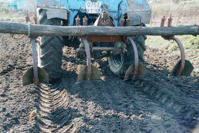 The Tractor Cultivates and Cuts Furrows in the Field. Tractor Work in ...
