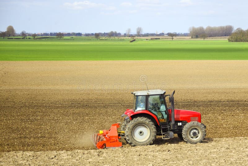 A tractor cultivating stock photo. Image of agriculture - 13973338
