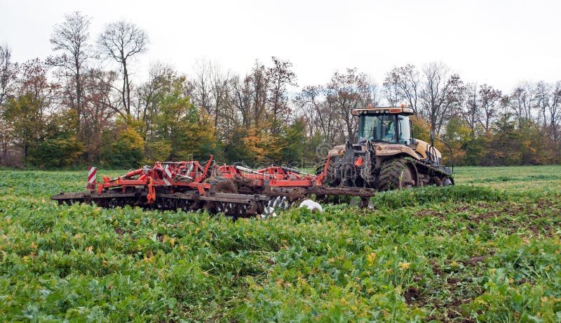 Tractor cultivating stock photo. Image of field, agriculture - 65539594