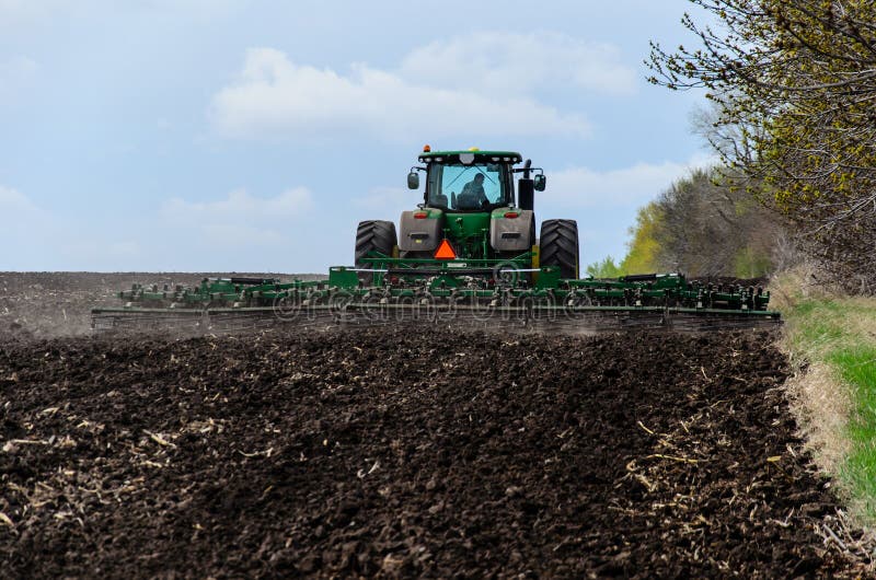 Tractor Cultivating Field at Spring. Spring Works Editorial Photo ...