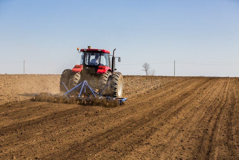 Tractor Cultivating Field at Spring Stock Photo - Image of plowed ...
