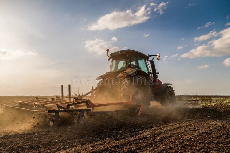 Tractor Cultivating Field At Spring Stock Image - Image of farmer ...