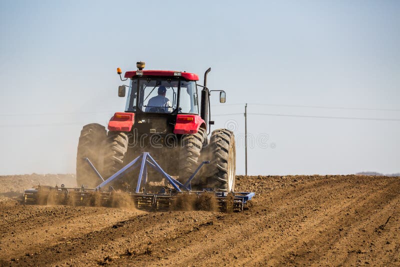 Tractor Cultivating Field at Spring Stock Image - Image of cultivating ...