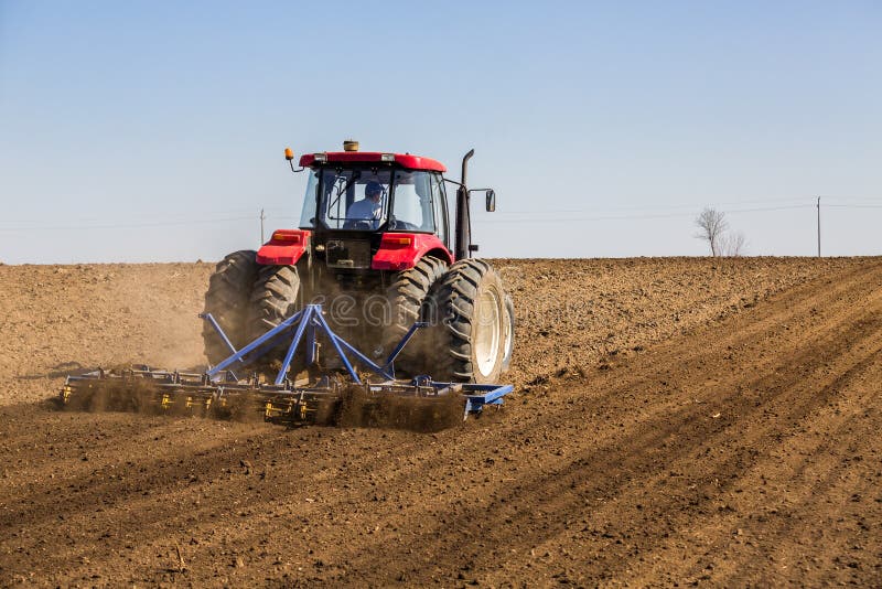 Tractor Cultivating Field at Spring Stock Photo - Image of farmer ...
