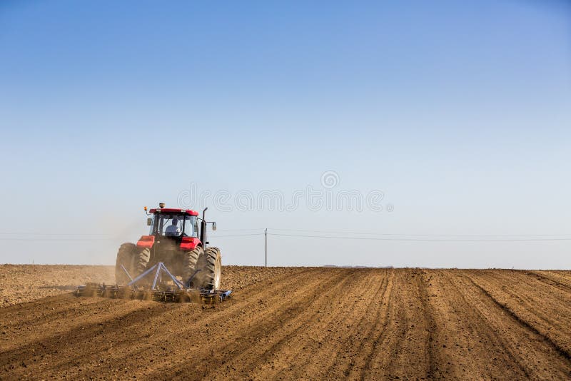 Tractor Cultivating Field at Spring Stock Image - Image of cultivated ...