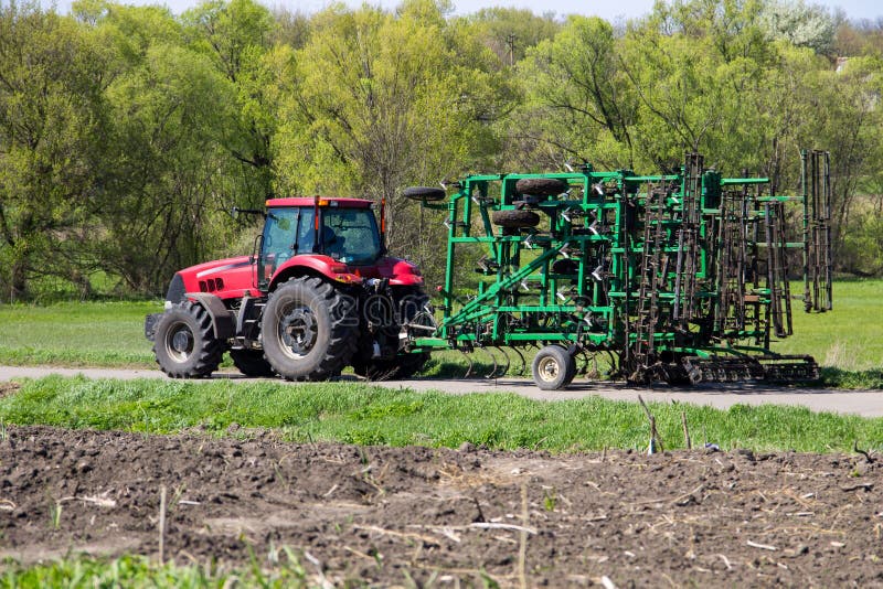 Tractor with Cultivator on Rural Road Stock Photo - Image of mechanism ...