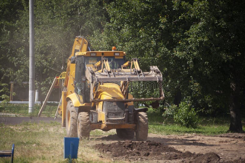 A Tractor Digs the Ground. the Work of the Tractor with the Bucket ...
