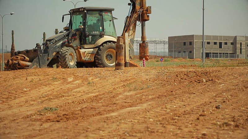 Tractor with Drilling Device, Drilling Soil on Ground at Construction ...