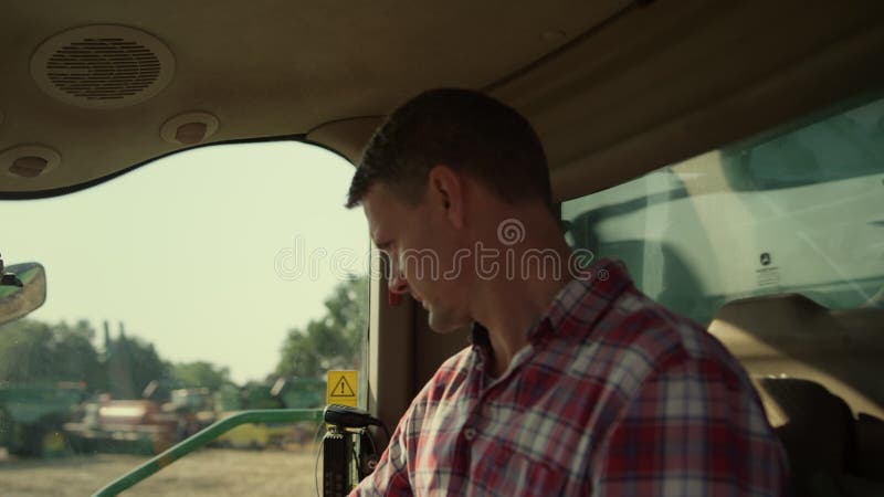 Tractor Driver Inside Cabin Checking Machinery Closeup. Focused Farmer ...