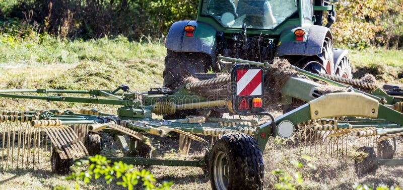 Tractor Drying Hay in a Hay Harvest Stock Photo - Image of tractor ...
