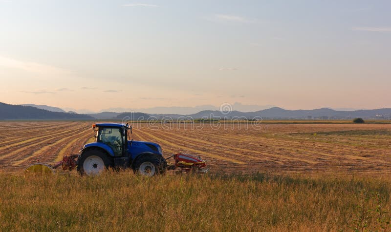 Tractor at the Edge of a Field at Sunset Stock Image - Image of plowed ...