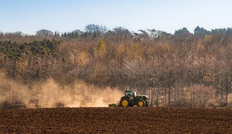 Tractor on Empty Fields Elevates a Huge Dust Cloud Back Lit by S ...