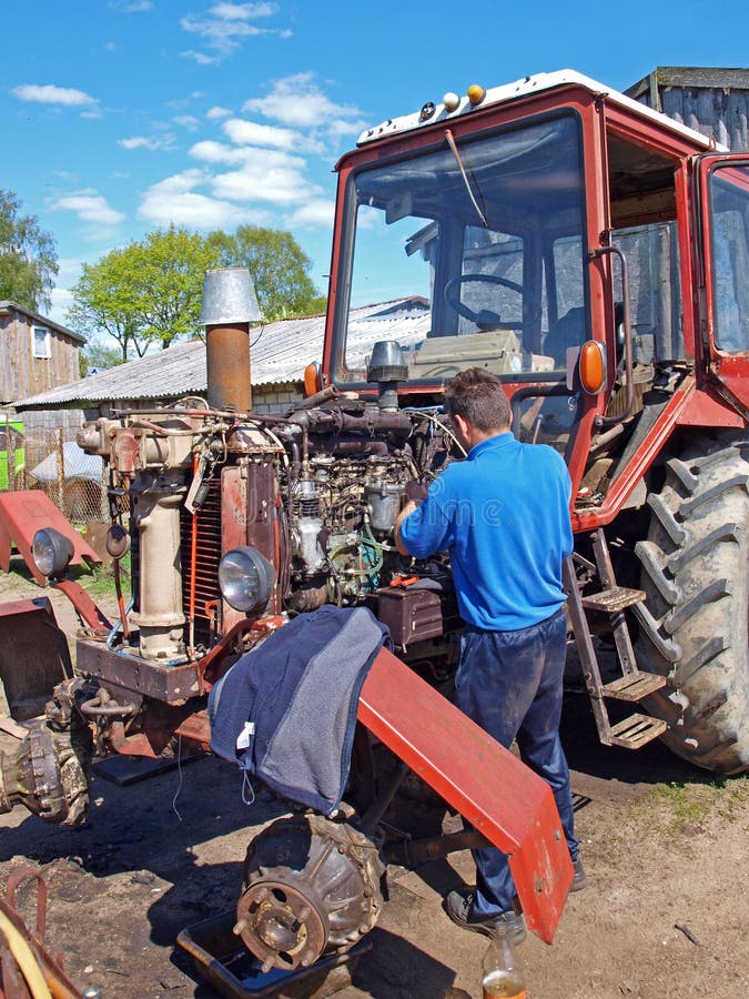 Tractor engine repairing 2 stock image. Image of work - 24925217