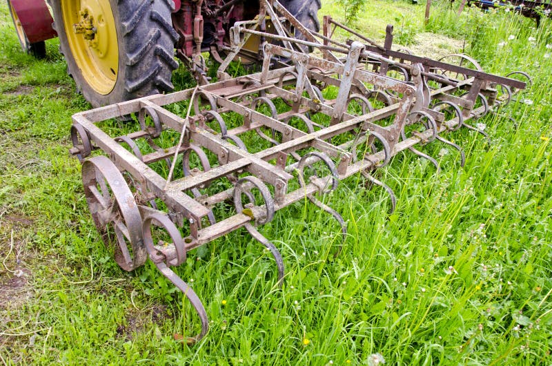 Tractor on Farm Field Gras with Metal Harrow Stock Photo - Image of ...