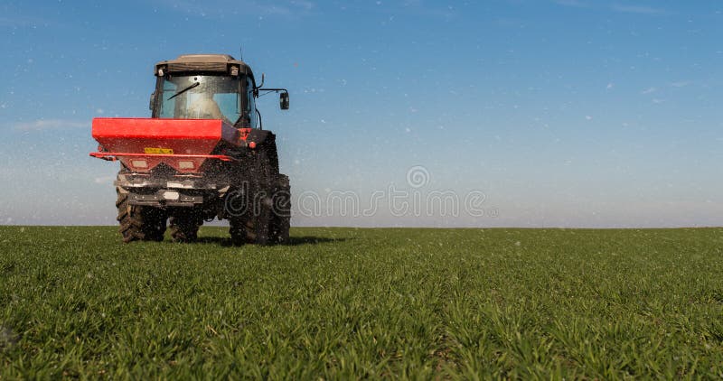 Tractor Fertilizing in Field Stock Photo - Image of agriculture ...
