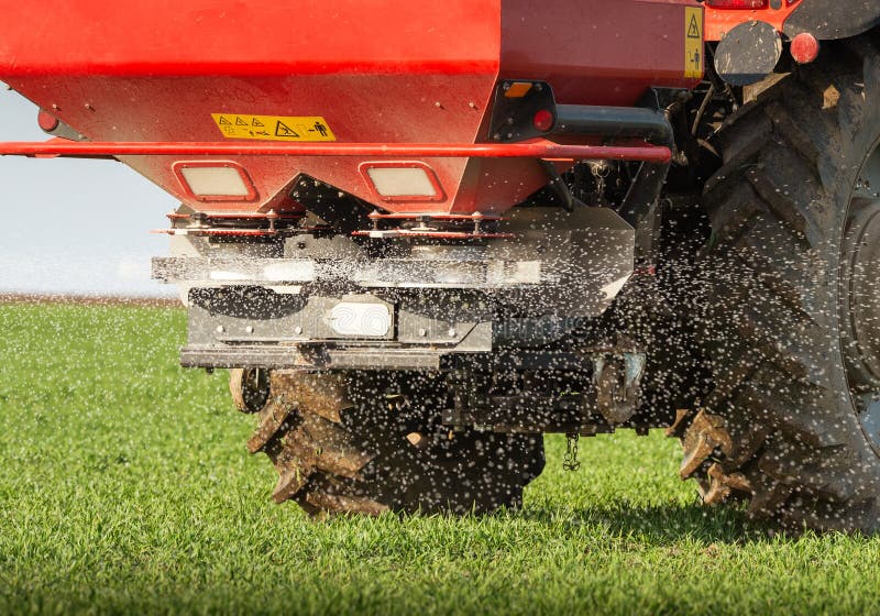 Tractor Fertilizing in Field Stock Image - Image of tractor, driving ...