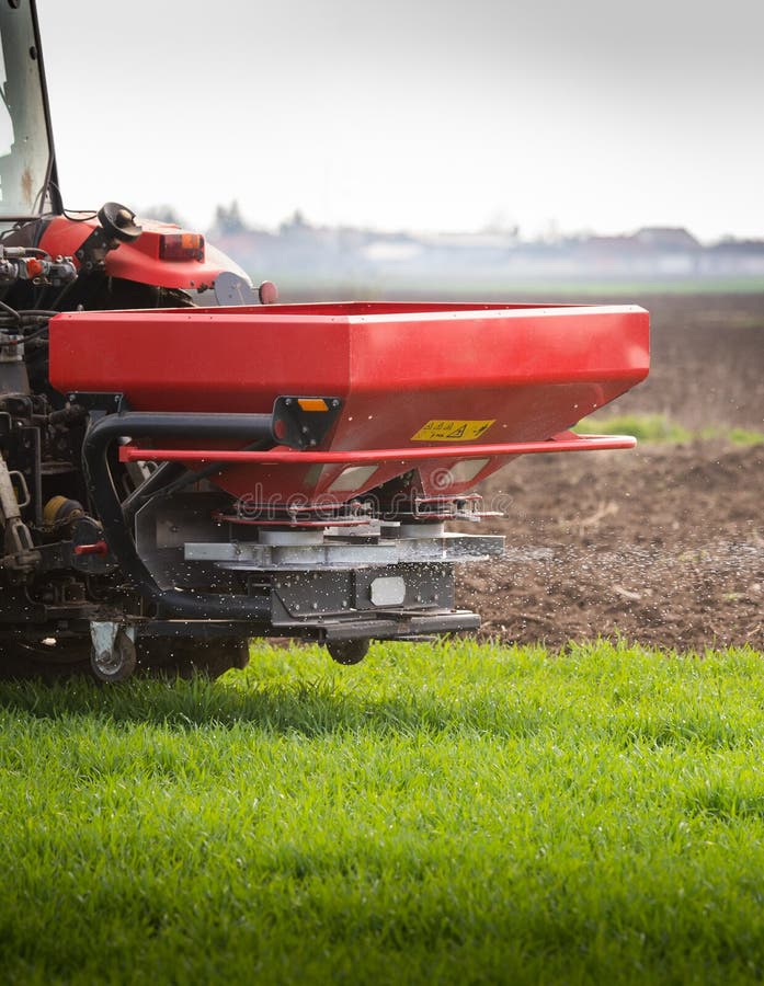 Tractor Fertilizing in Field Stock Image - Image of transportation ...