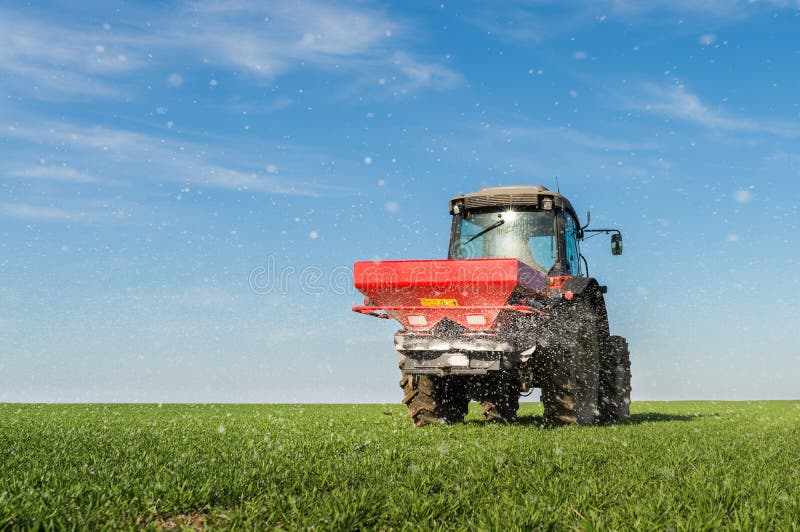 Tractor Fertilizing in Field Stock Image - Image of outdoors, spreading ...