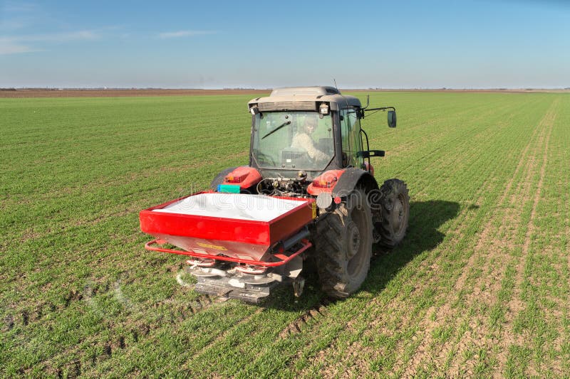 Tractor Fertilizing in Field Stock Photo - Image of horizontal ...