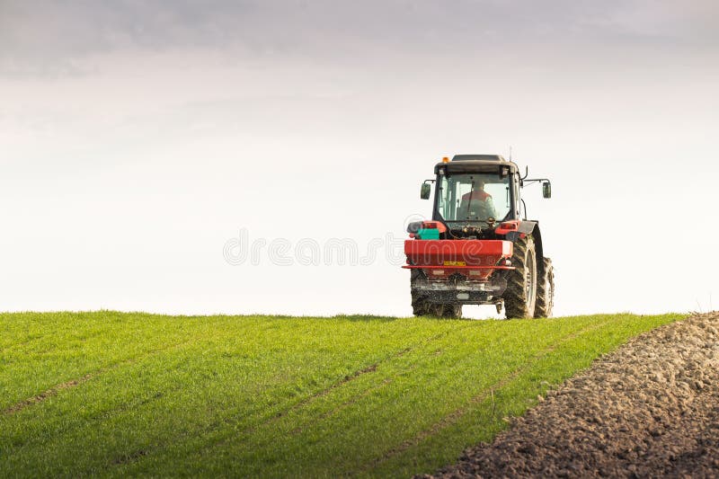 Tractor Fertilizing in Field Stock Image - Image of horizontal, crop ...