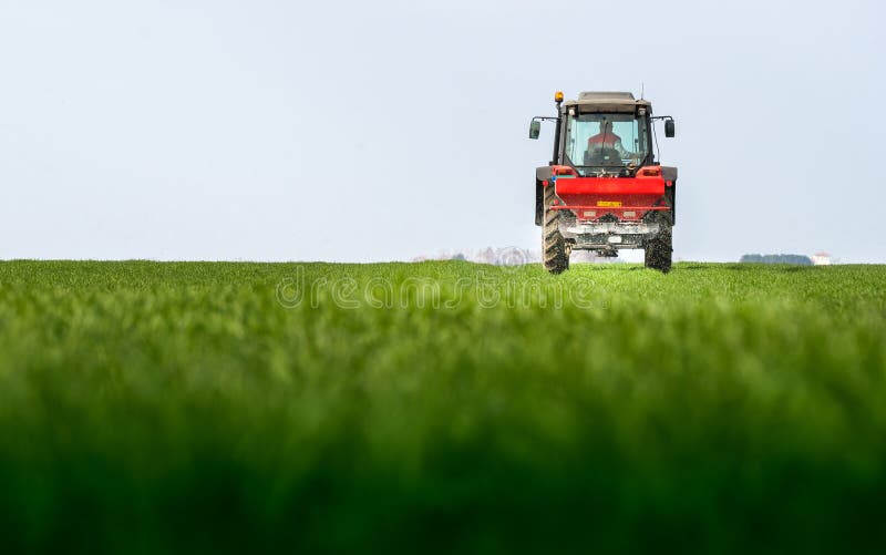Tractor Fertilizing in Field Stock Photo - Image of fertilizer, farming ...