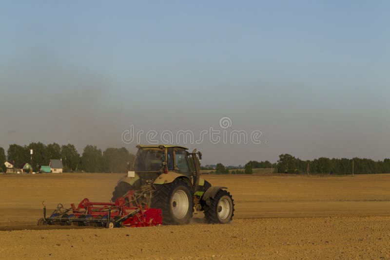 The Tractor in the Field on Agricultural Operations Stock Image - Image ...