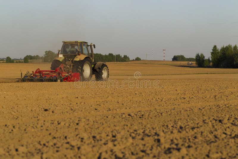 The Tractor in the Field on Agricultural Operations Stock Photo - Image ...