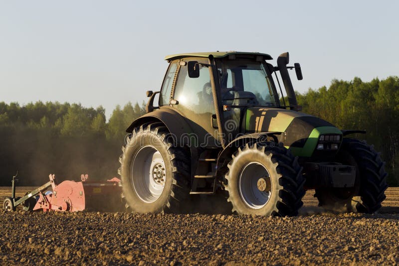 The Tractor in the Field on Agricultural Operations Stock Photo - Image ...