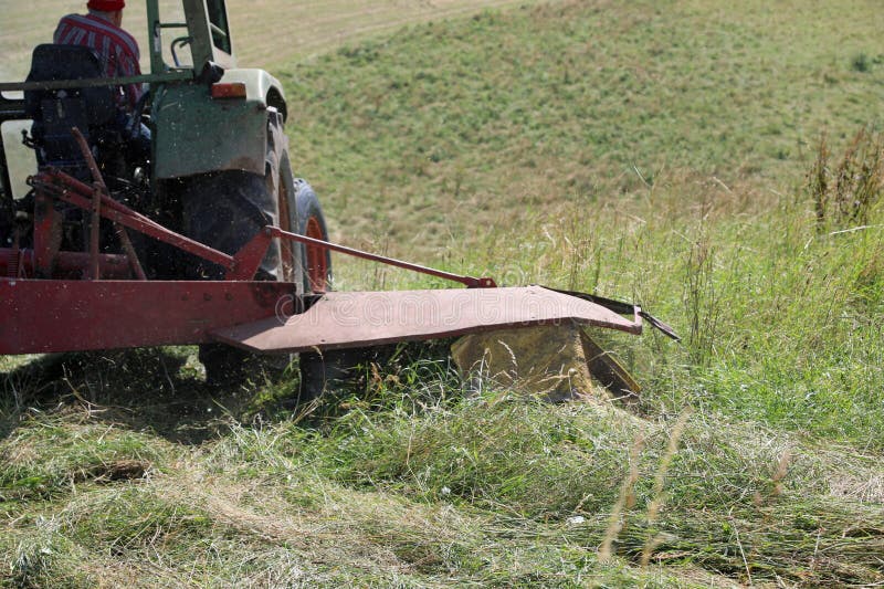 Tractor in a Field of Grass and a Rotary Tiller Aerating the Soil after ...
