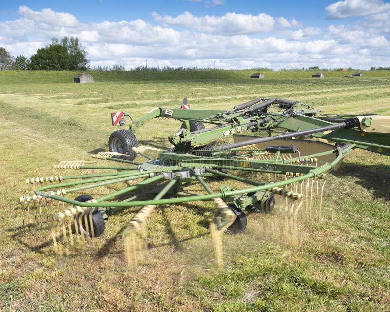 Tractor in Field with Grass Tedder during Hay Harvest in the ...