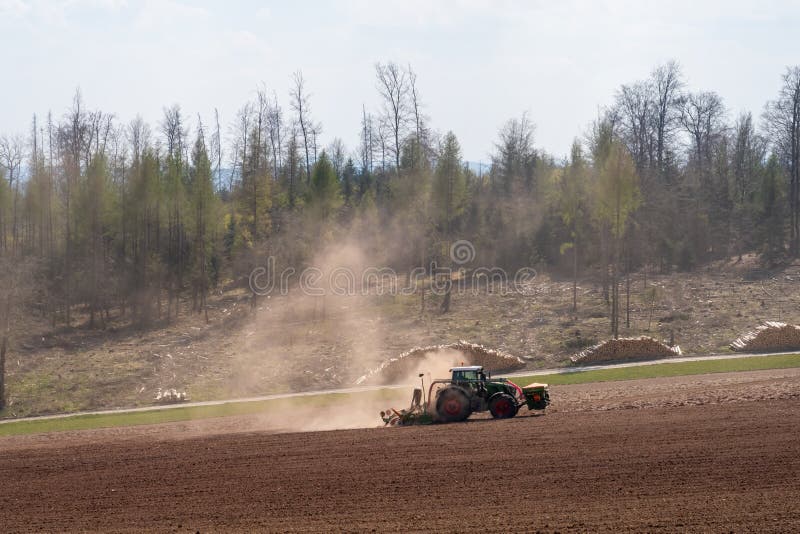 Tractor on the Field with a Lost of Dust because of the Dry Field Stock ...