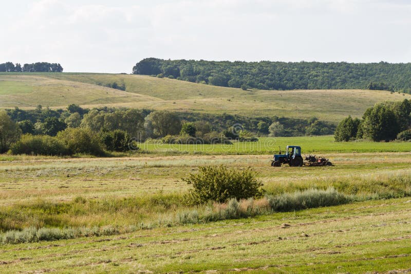 Tractor in a field stock image. Image of landscape, tractors - 99826383