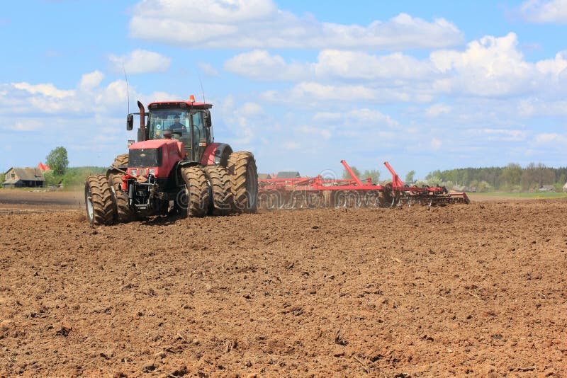 Tractor on the field editorial stock photo. Image of plowing - 56313518
