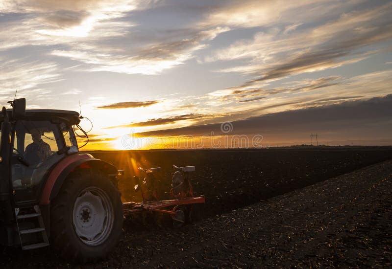Tractor on the Field during Sunset Stock Photo - Image of land, side ...