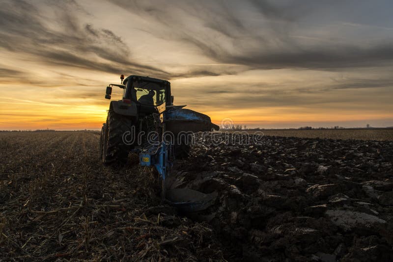 Tractor on the Field during Sunset Stock Photo - Image of farm, black ...