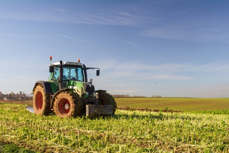 Tractor in the fields stock photo. Image of countryside - 196704260