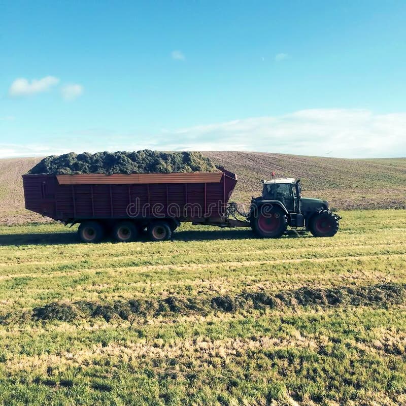 Tractor with Garbage Trailer Spread on the Field Stock Image - Image of ...