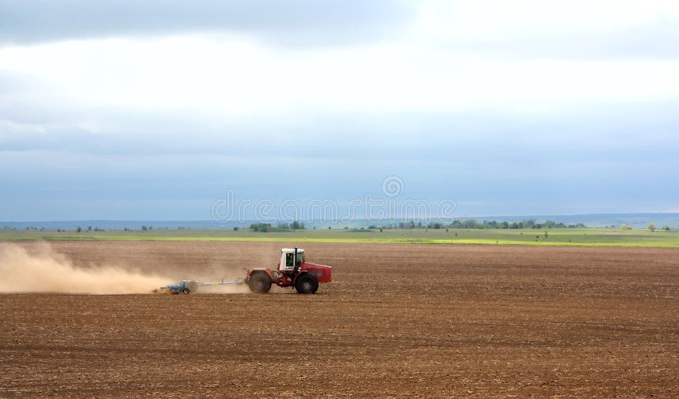 A Tractor Handles the Ground Stock Photo - Image of digging, field ...