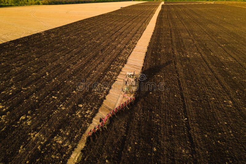 Tractor with Harrow System Plowing Ground Farm Field Stock Image ...