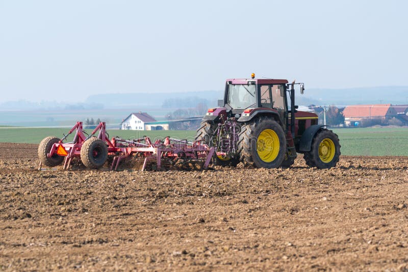 Tractor Harrowing the Field Stock Photo - Image of growth, cultivating ...