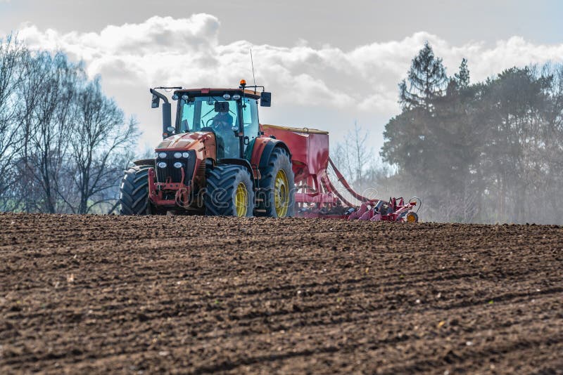 Tractor Harrowing the Field Stock Photo - Image of industry, industrial ...