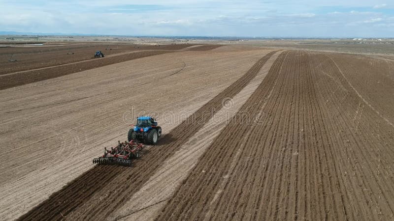 Tractor harrowing field stock video. Video of parallel - 253978383